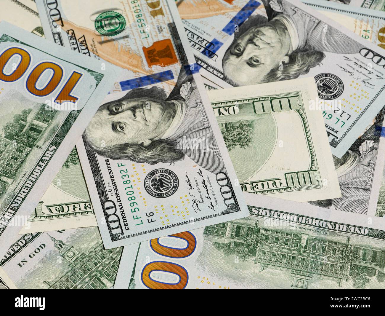 Flat texture and background of real $100 bills, numbers are different ...