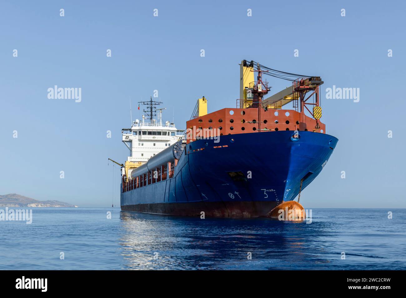 Blue dry cargo ship at sea. Multi purposes vessel carrying wind ...