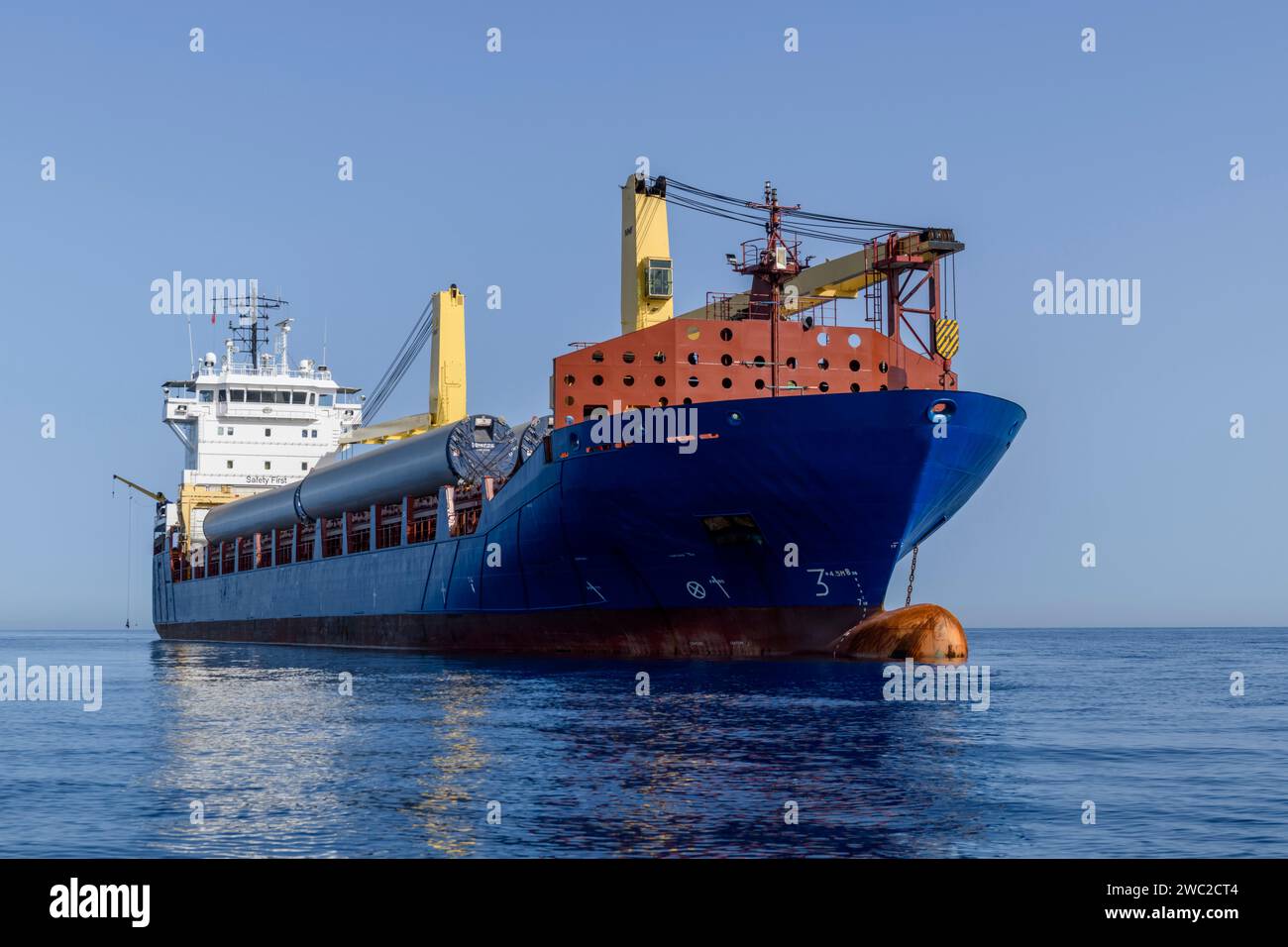 Blue dry cargo ship at sea. Multi purposes vessel carrying wind ...