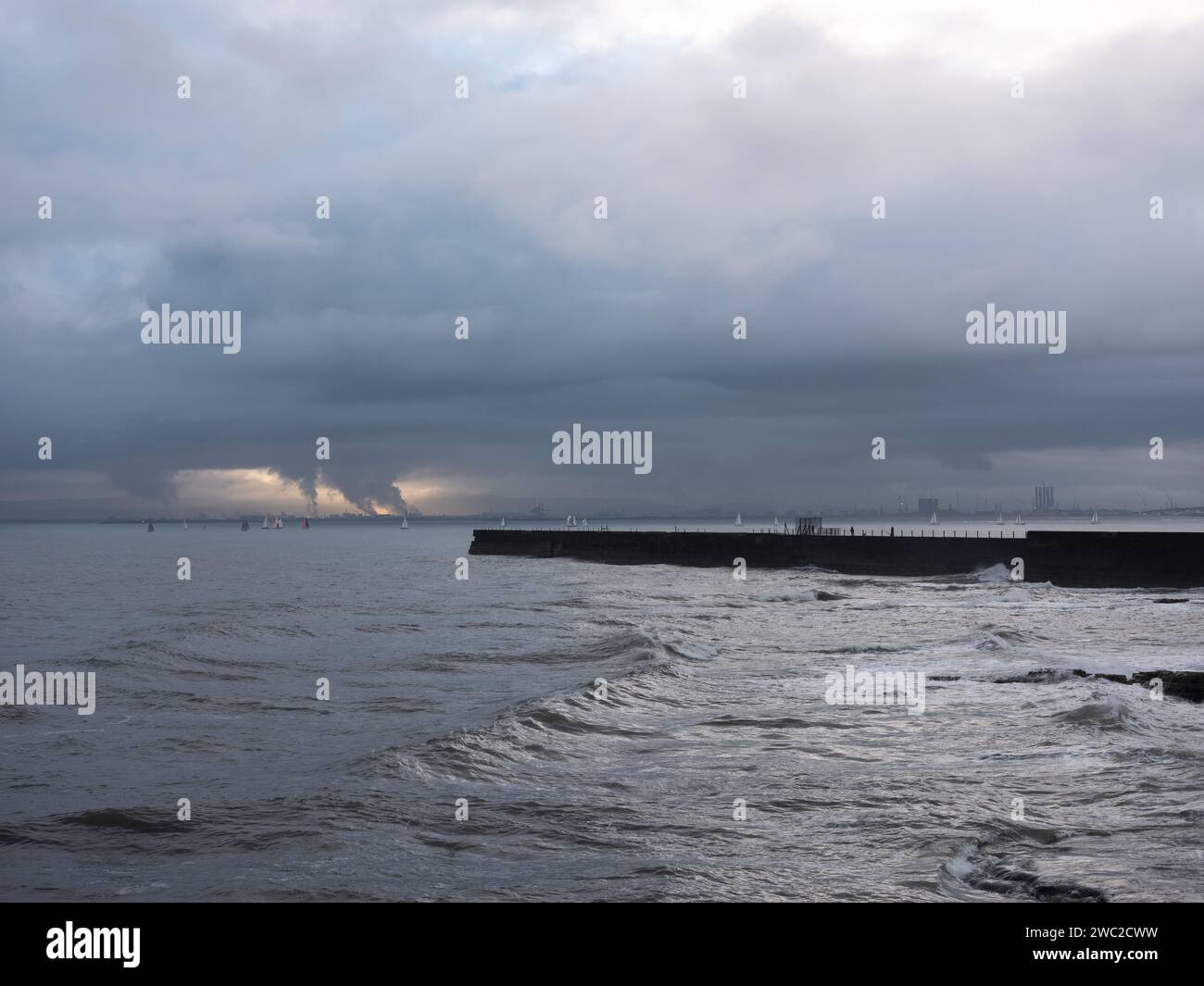 The Heugh pier at Hartlepool headland with a view of Teesside in the ...