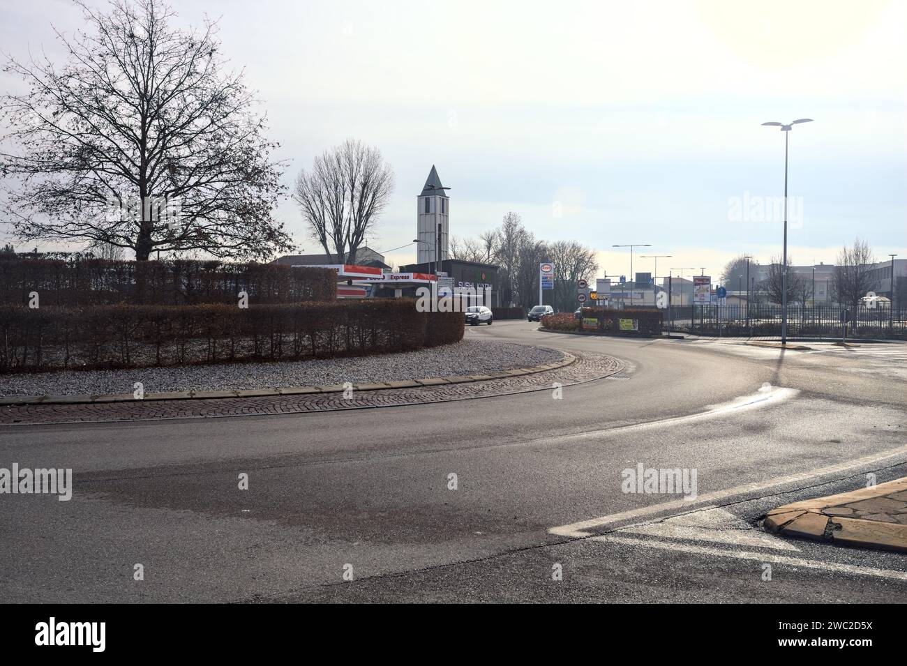 Roundabout with a bell tower and a gas station next to it in a village ...