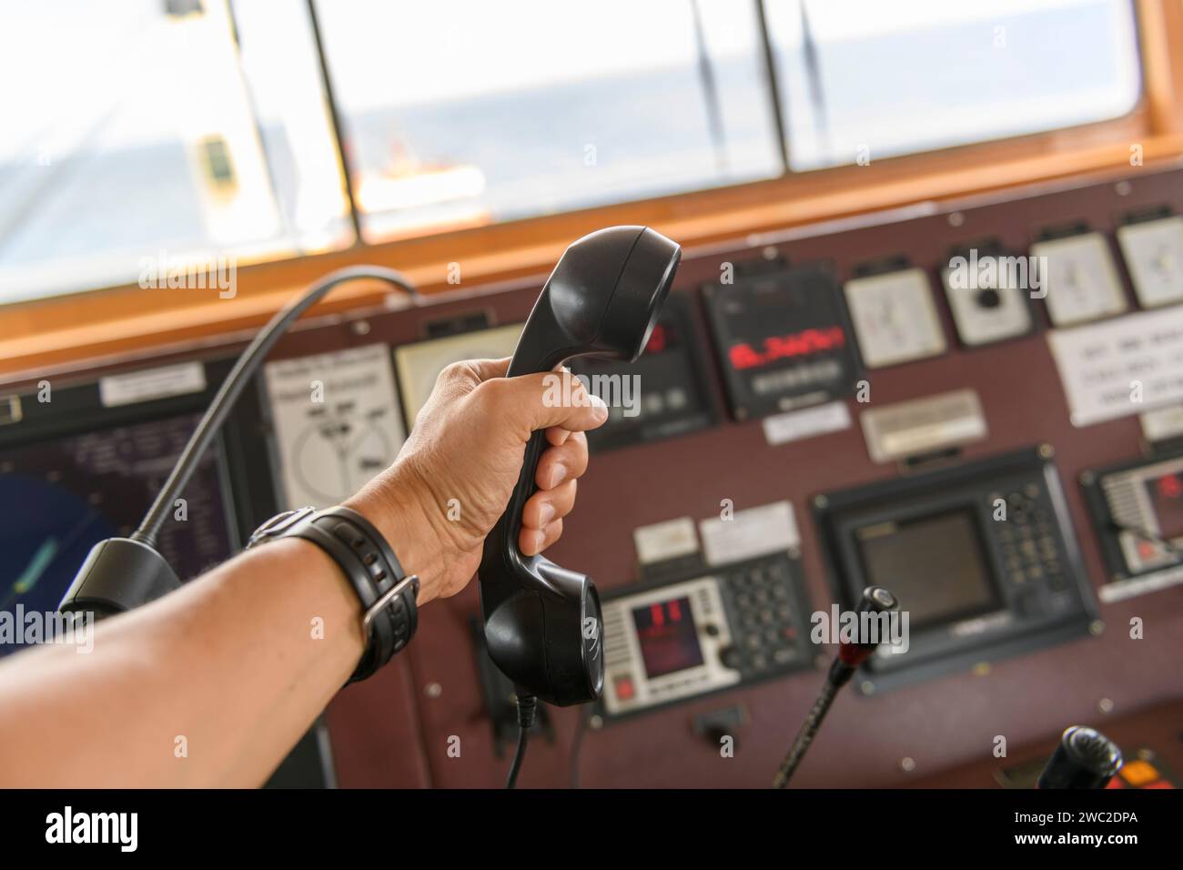 Navigational control panel and VHF radio with hand. Radio communication ...