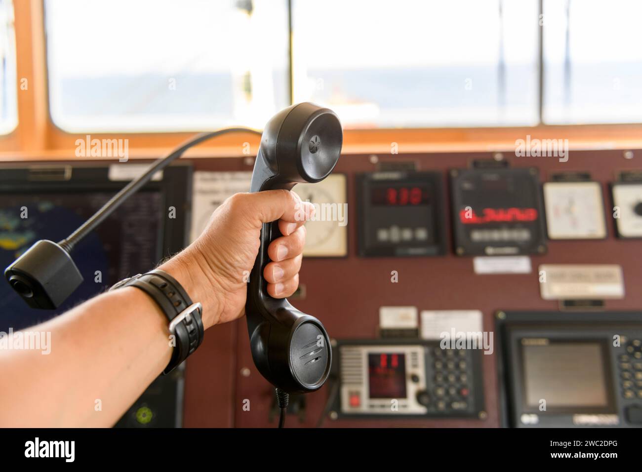Navigational control panel and VHF radio with hand. Radio communication ...