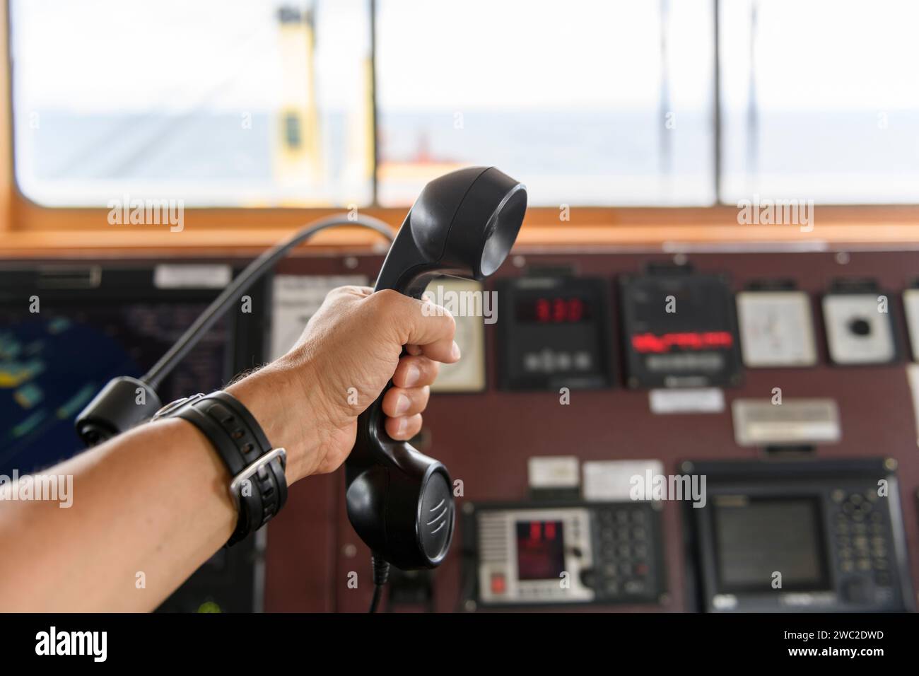 Navigational control panel and VHF radio with hand. Radio communication ...