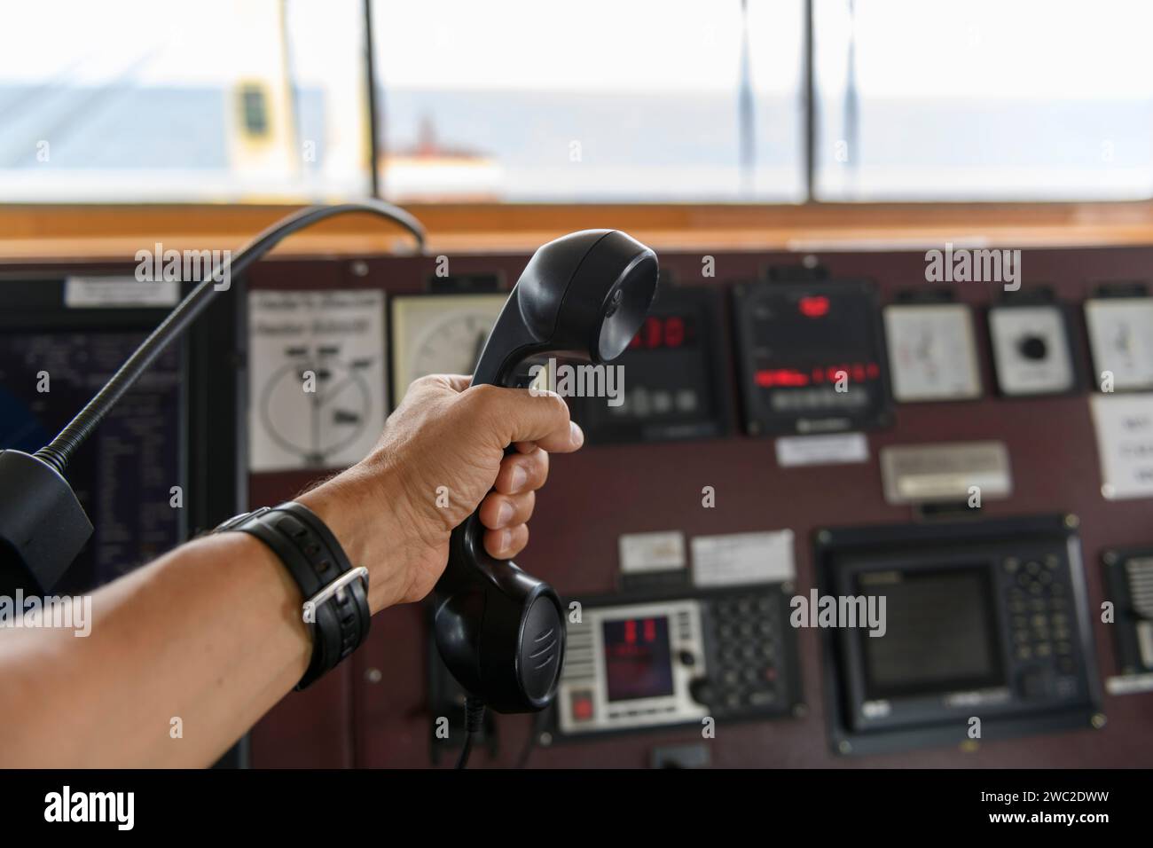 Navigational control panel and VHF radio with hand. Radio communication ...