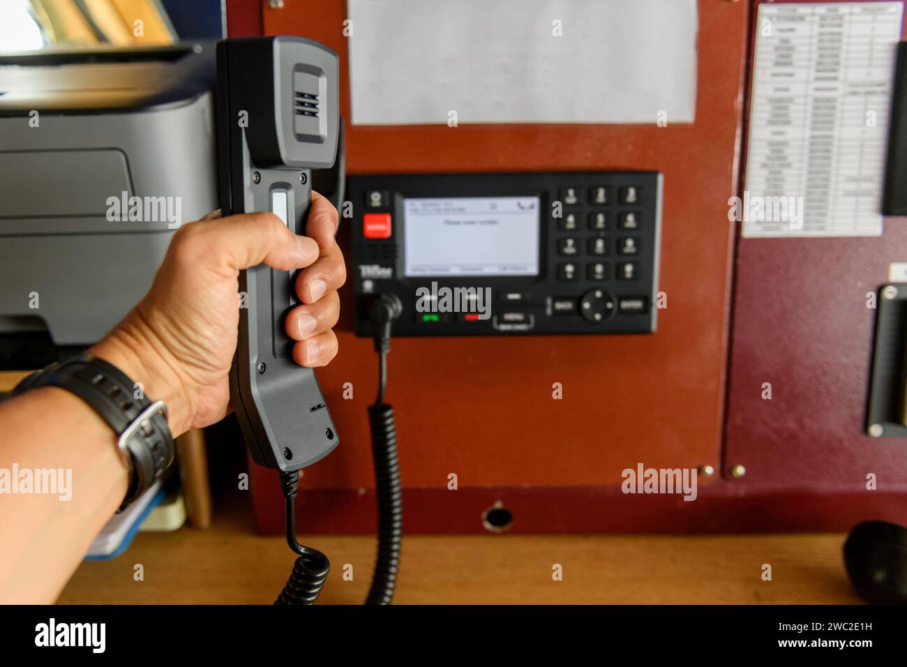 Navigational control panel and VHF radio with hand. Radio communication ...