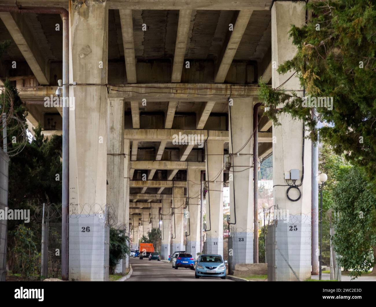 Sochi, Russia - February 2023, 23: Road with parked cars under a car ...