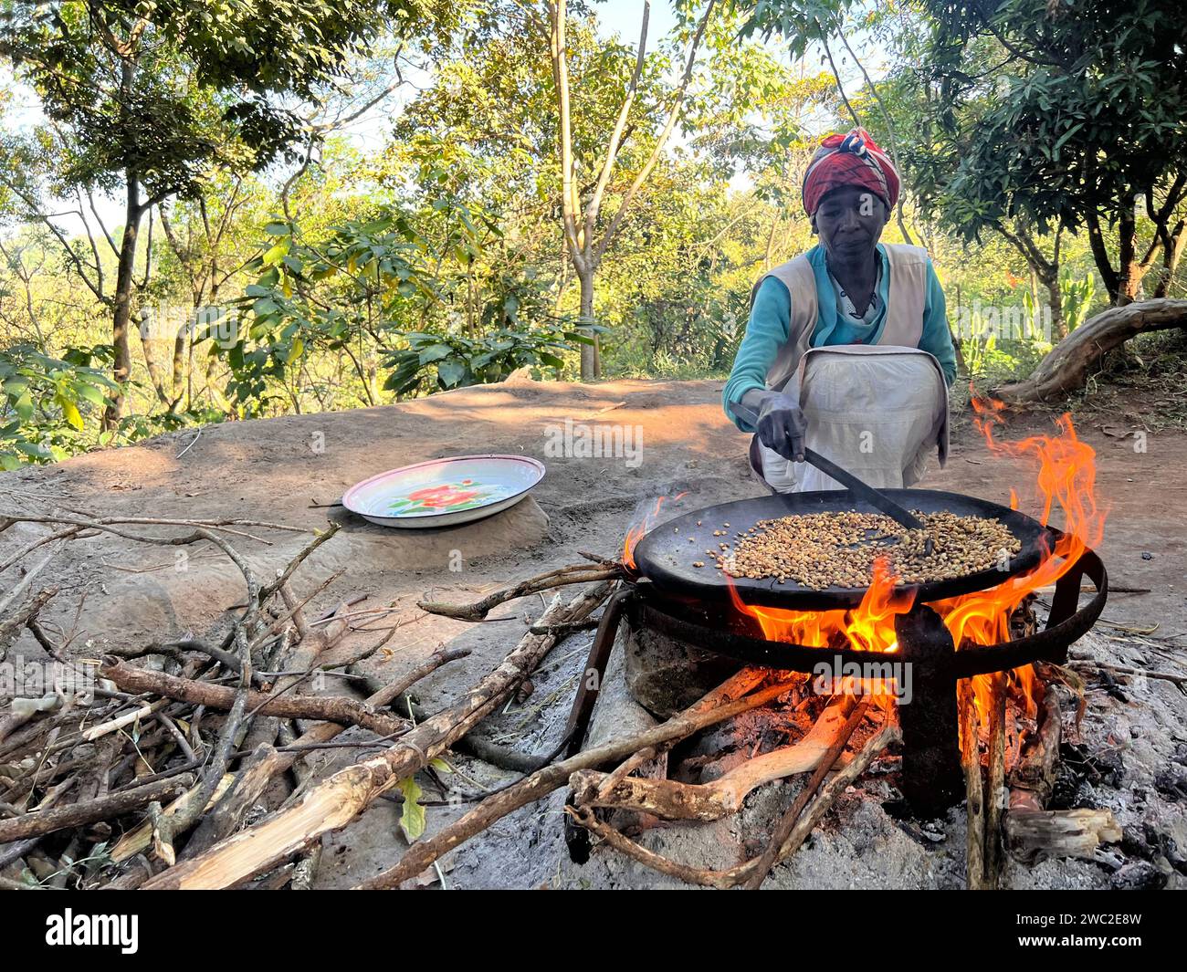 Yirga Alem, Ethiopia, Febuary 20th, 2023 ; woman cooking coffee to make ...