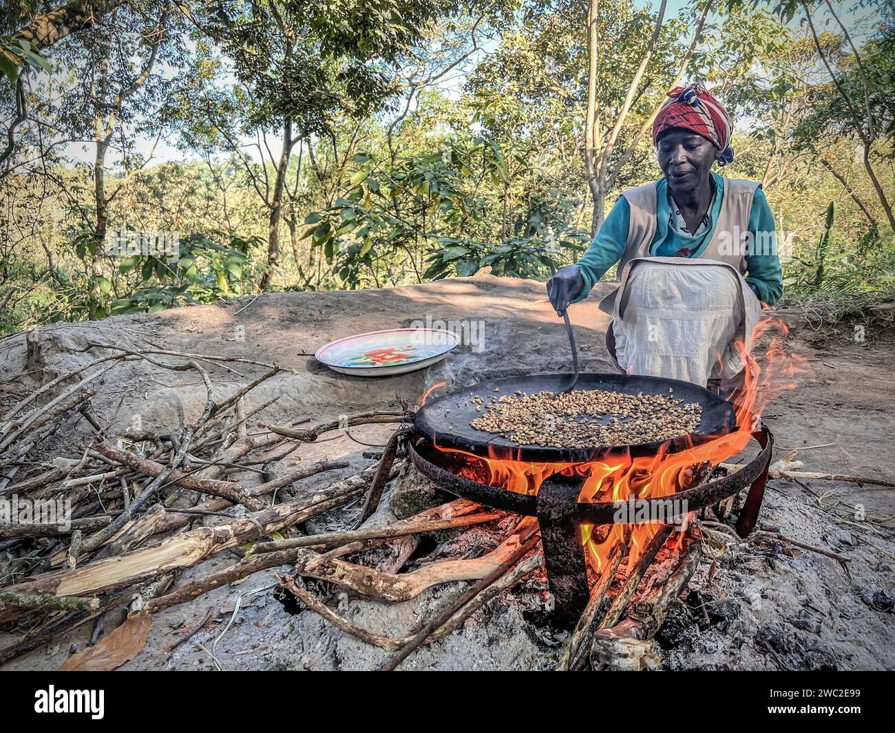 Yirga Alem, Ethiopia, Febuary 20th, 2023 ; woman cooking coffee to make ...