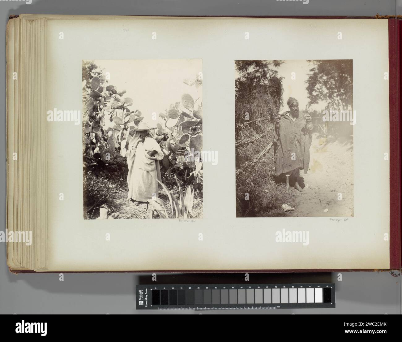 Portrait of a man -dressed man with a clapper on a sandy road in ...