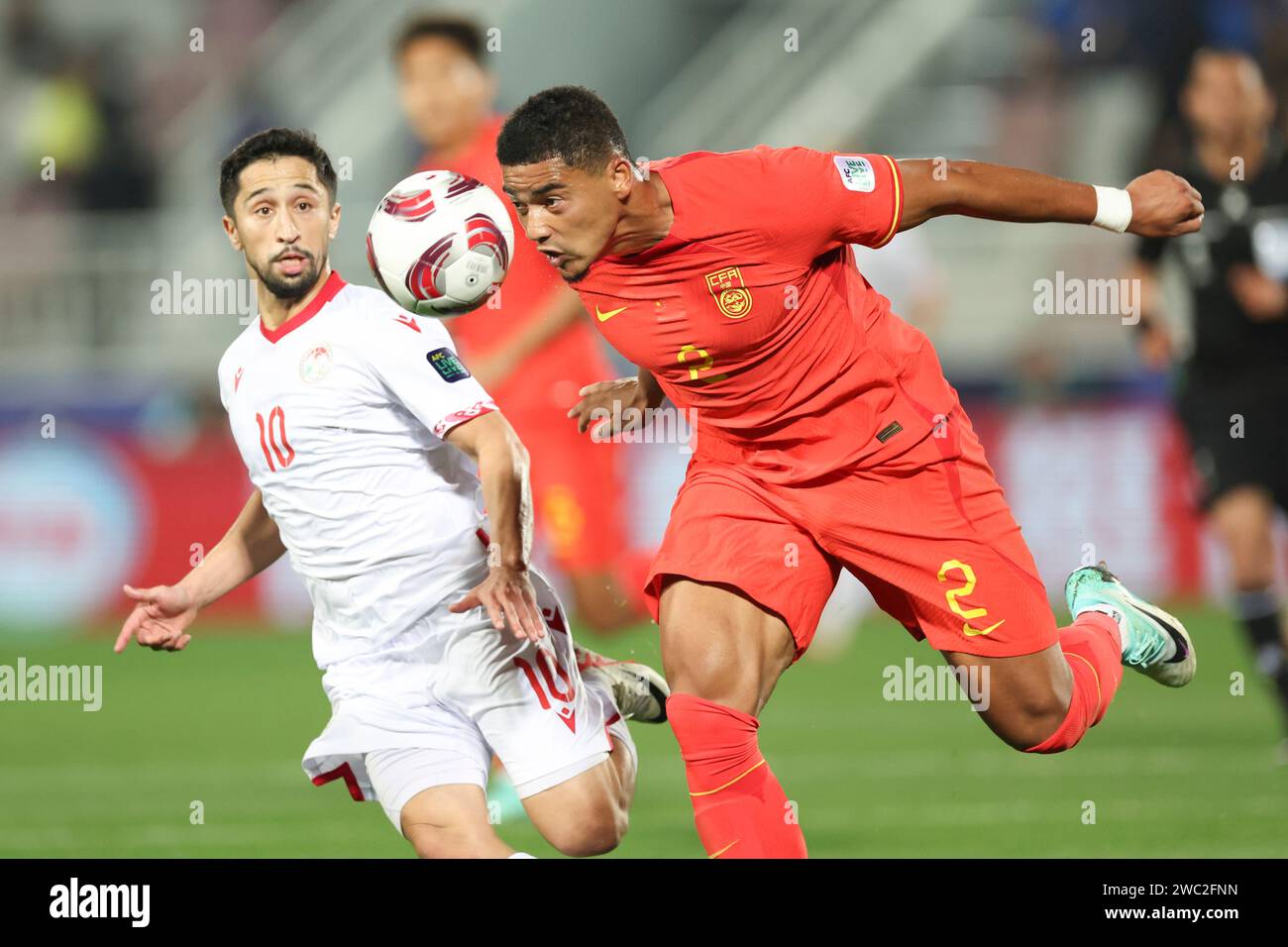 Doha, Qatar. 13th Jan, 2024. Jiang Guangtai (R) of China vies with Dzhalilov Alisher of ...