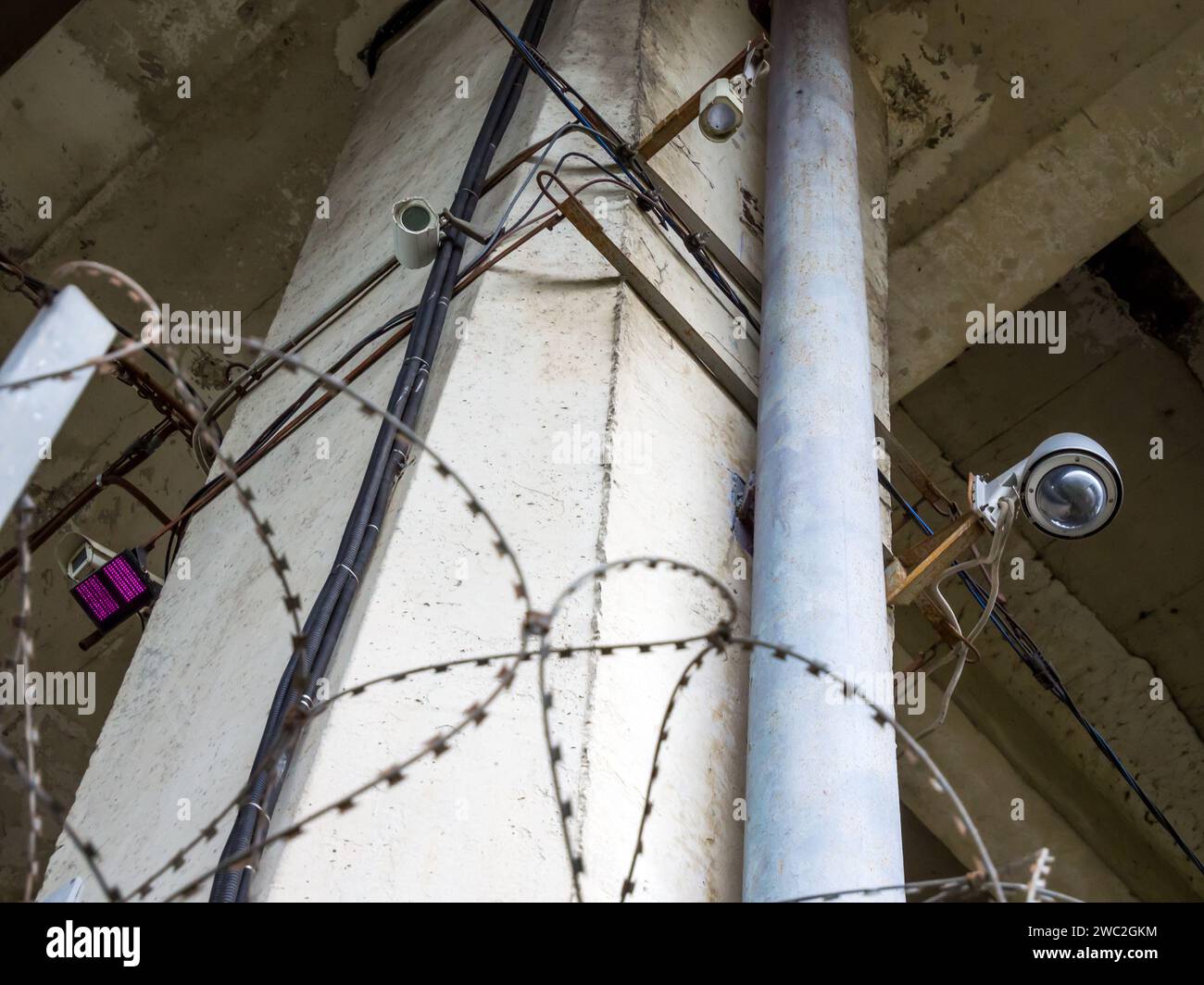 Bridge support protected by barbed wire and equipped with video ...