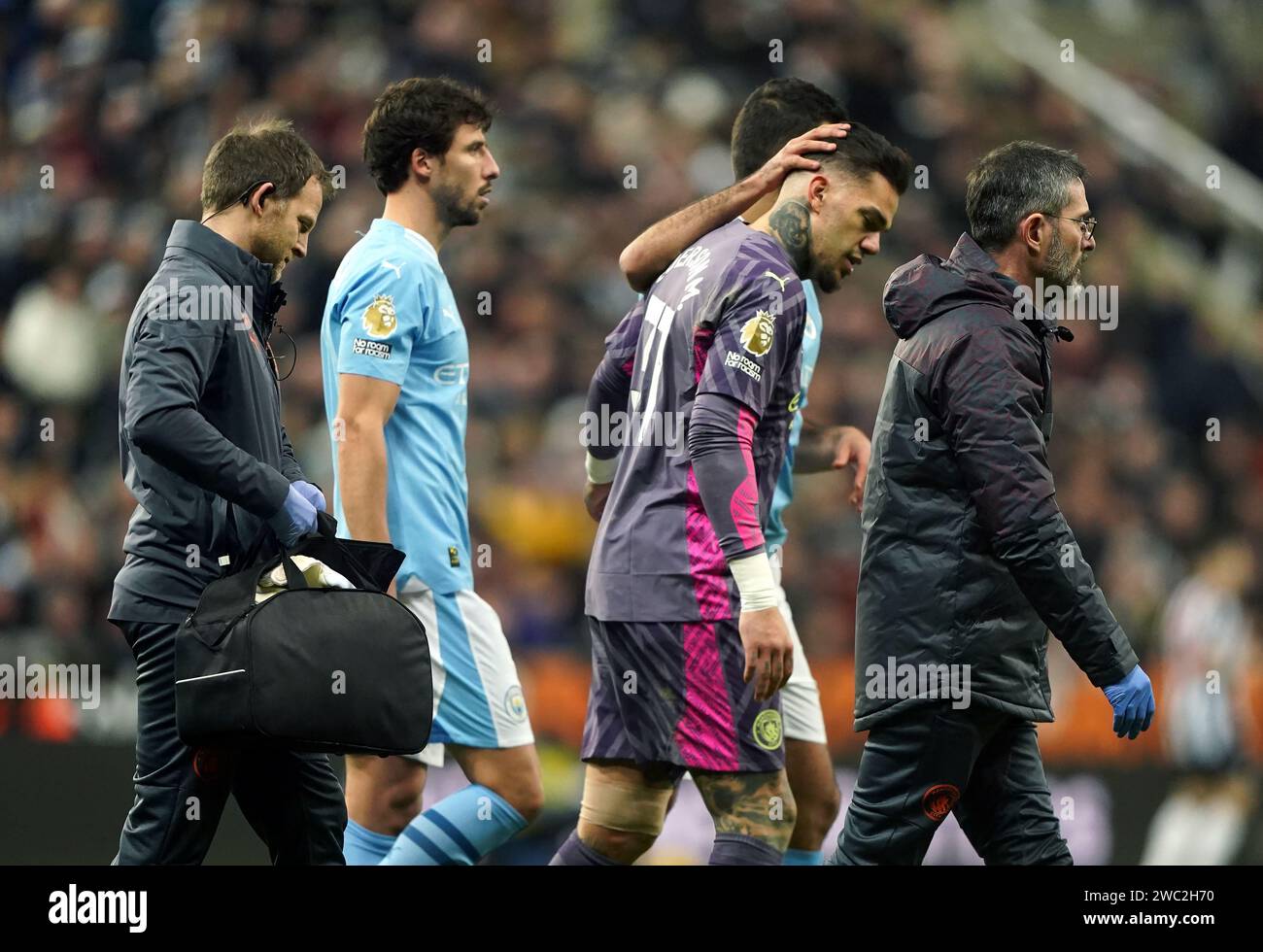 Manchester City goalkeeper Ederson leaves the pitch after picking up an injury during the ...
