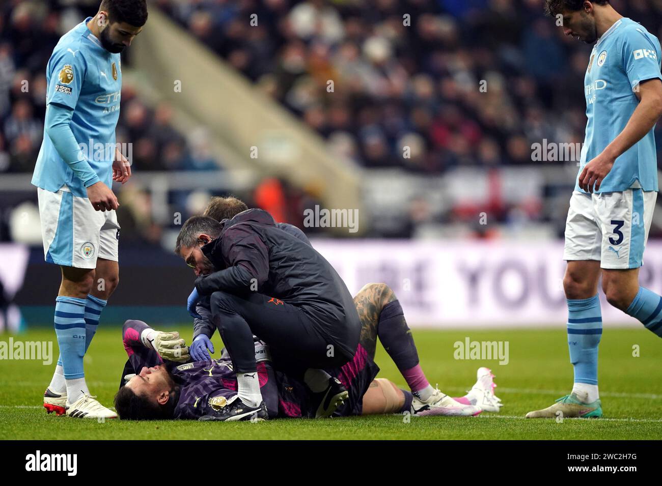 Manchester City goalkeeper Ederson receives treatment for an injury ...