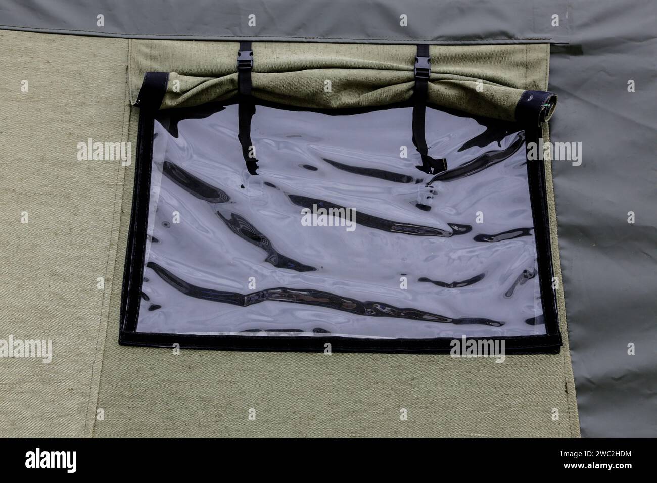 Tent window close-up. Plastic window in canvas tent Stock Photo - Alamy