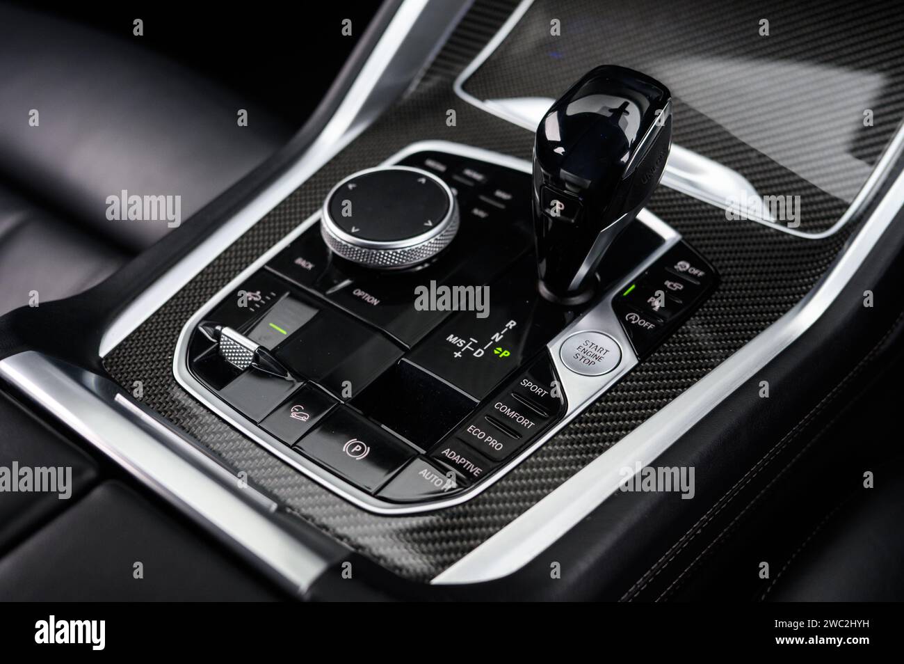 A close-up view of a car shift knob with its buttons and controls ...