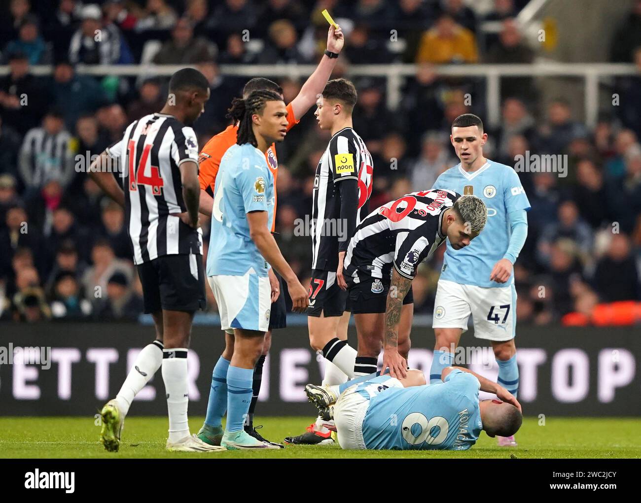 Referee Chris Kavanagh shows a yellow card to Newcastle United's Bruno ...