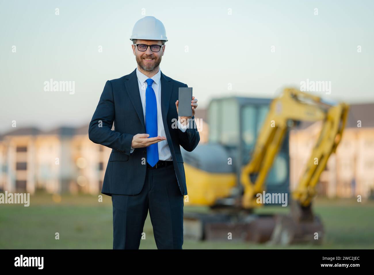 Successful construction business owner. Construction worker in suit and ...