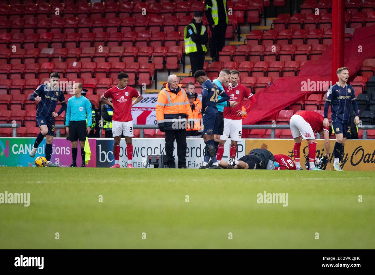 Crewe Alexandra's Conor Thomas receives medical treatment after a challenge from Swindon Town's ...