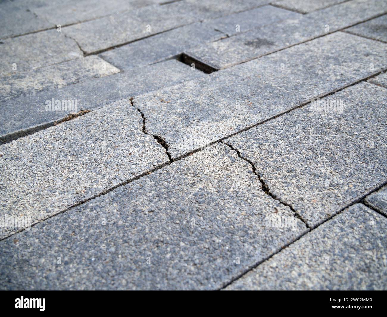 Cracked new granite paving slab Stock Photo - Alamy