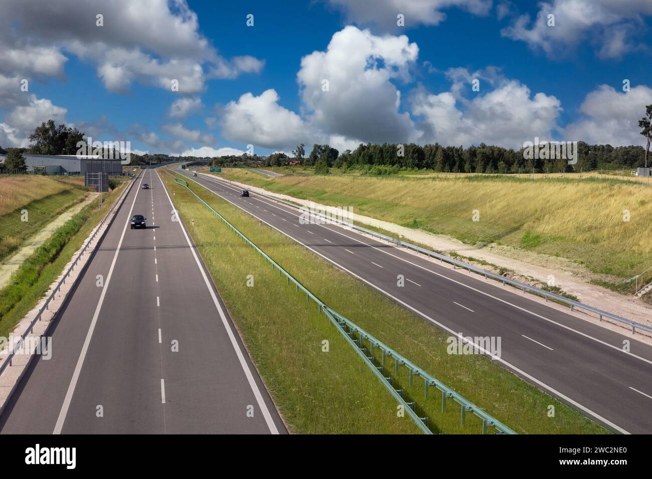 Highway construction. Pouring asphalt, installing sound barriers. Heavy ...