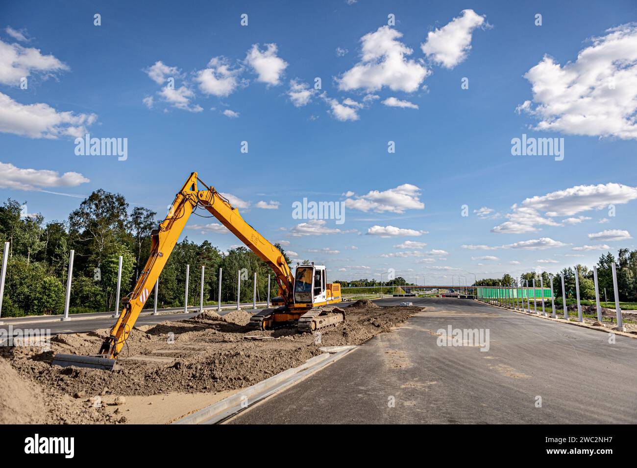Highway construction. Pouring asphalt, installing sound barriers. Heavy ...