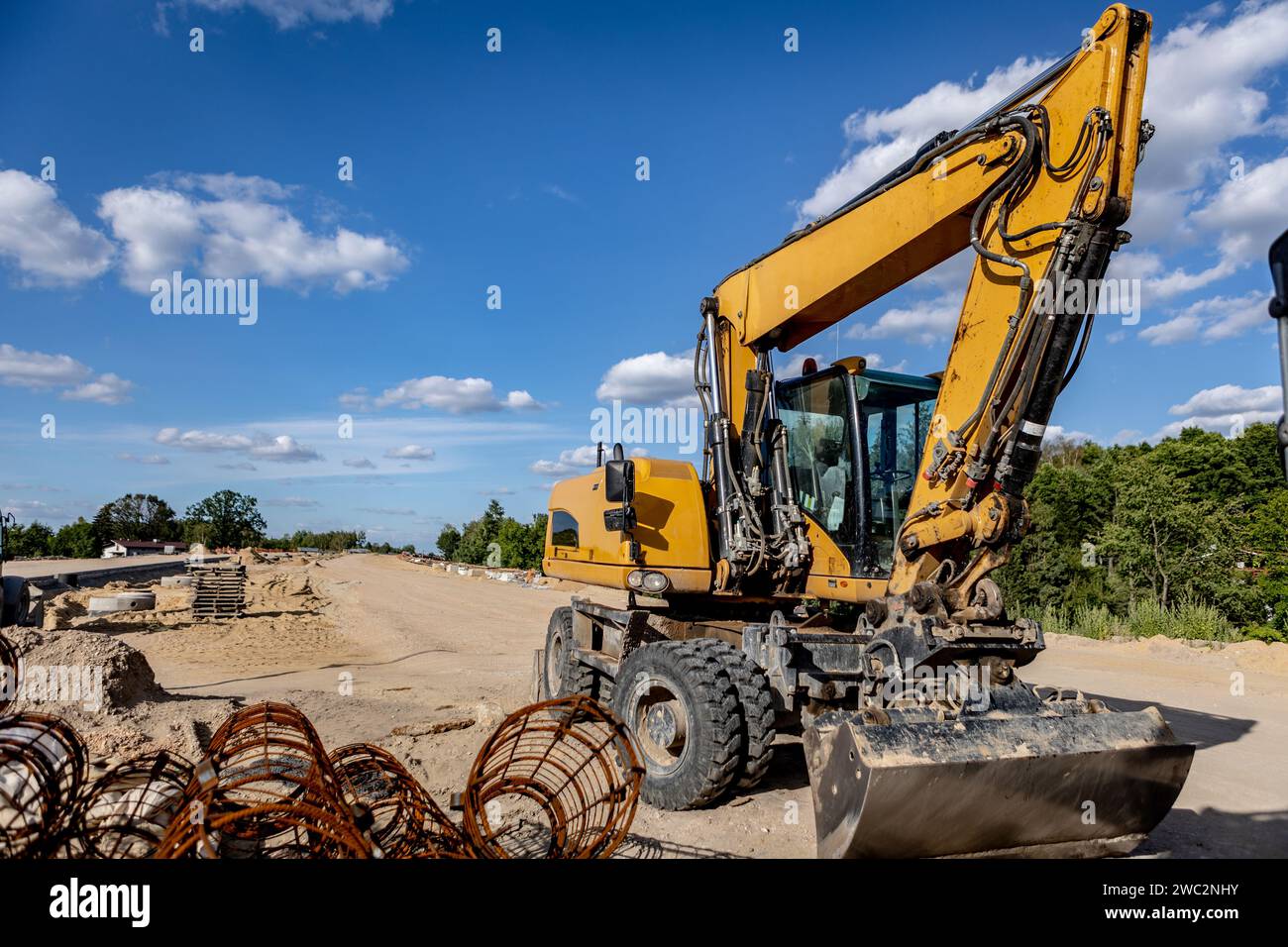 Highway construction. Pouring asphalt, installing sound barriers. Heavy ...