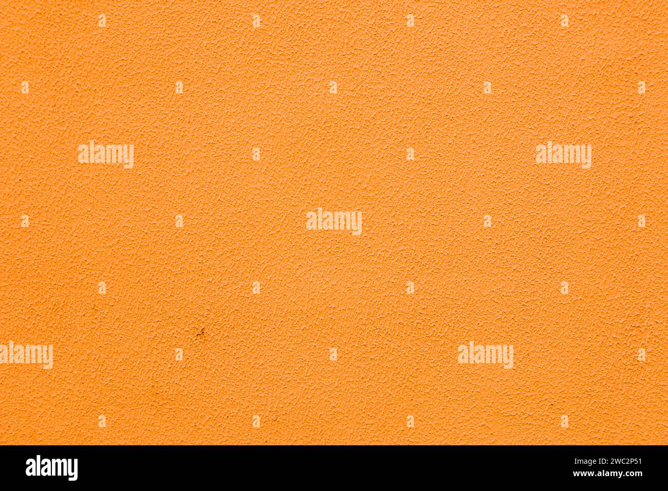 A wall with worn orange plaster Stock Photo - Alamy