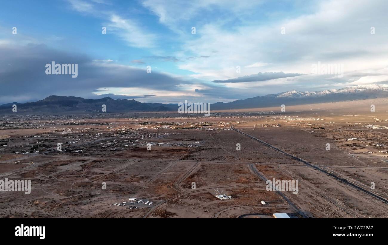 An aerial view of a town in the desert with a cloudy sky above. Pahrump ...