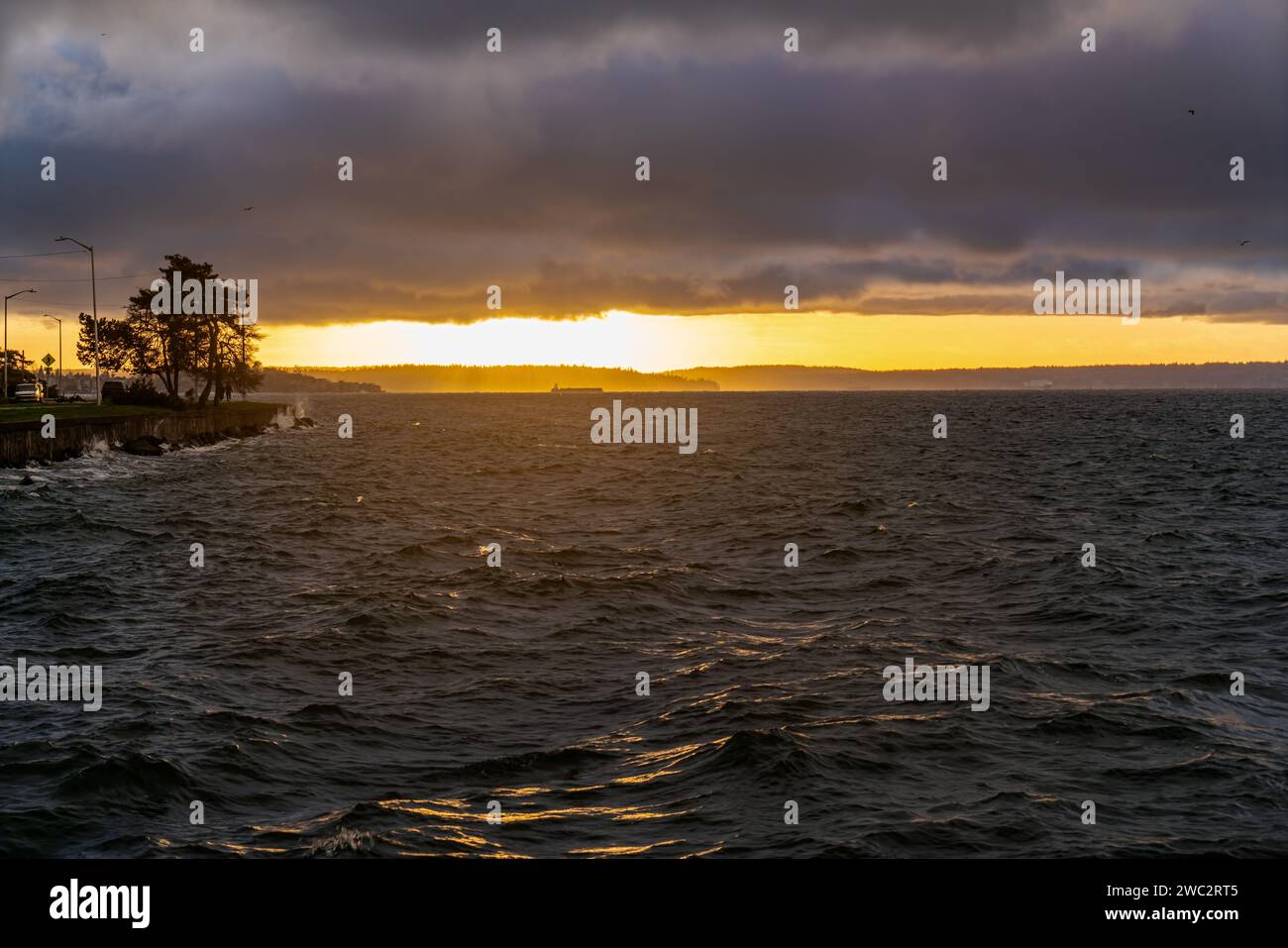 A golden sunset seen from Alki Beach in West Seattle, Washington Stock ...
