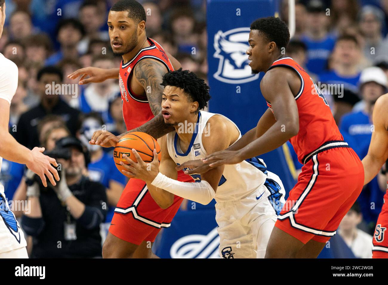 Creighton's Trey Alexander, center, passes the ball from between St ...