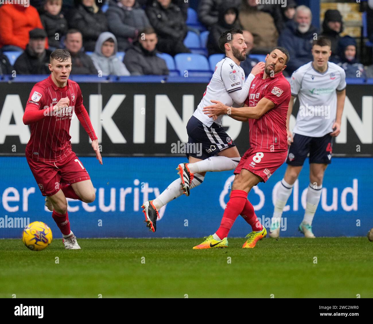 Josh Sheehan of Bolton Wanderers runs into Liam Sercombe of Cheltenham ...