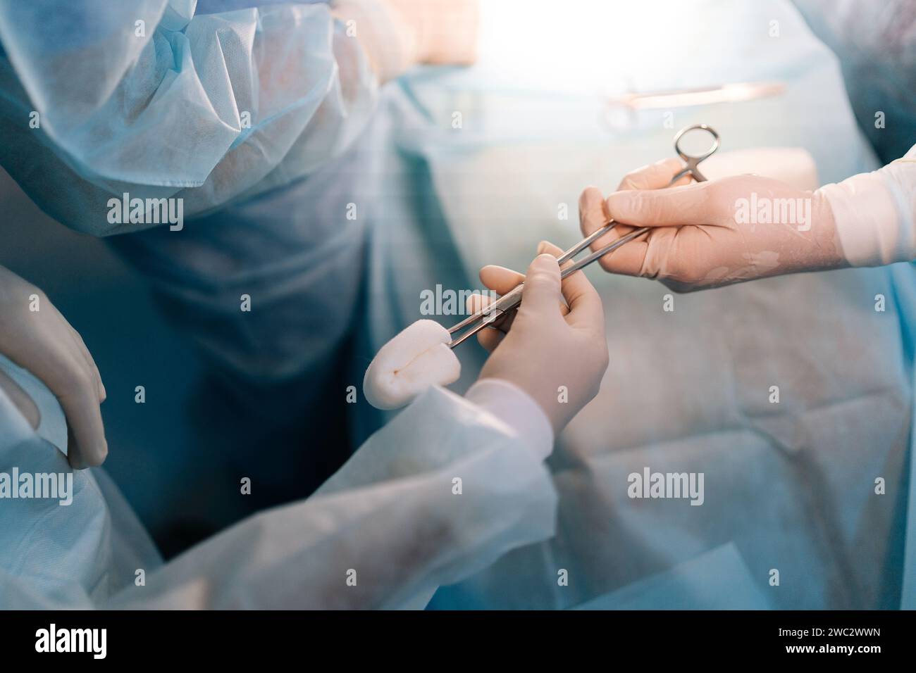 Closeup top view of unrecognizable African nurse assists surgeons ...
