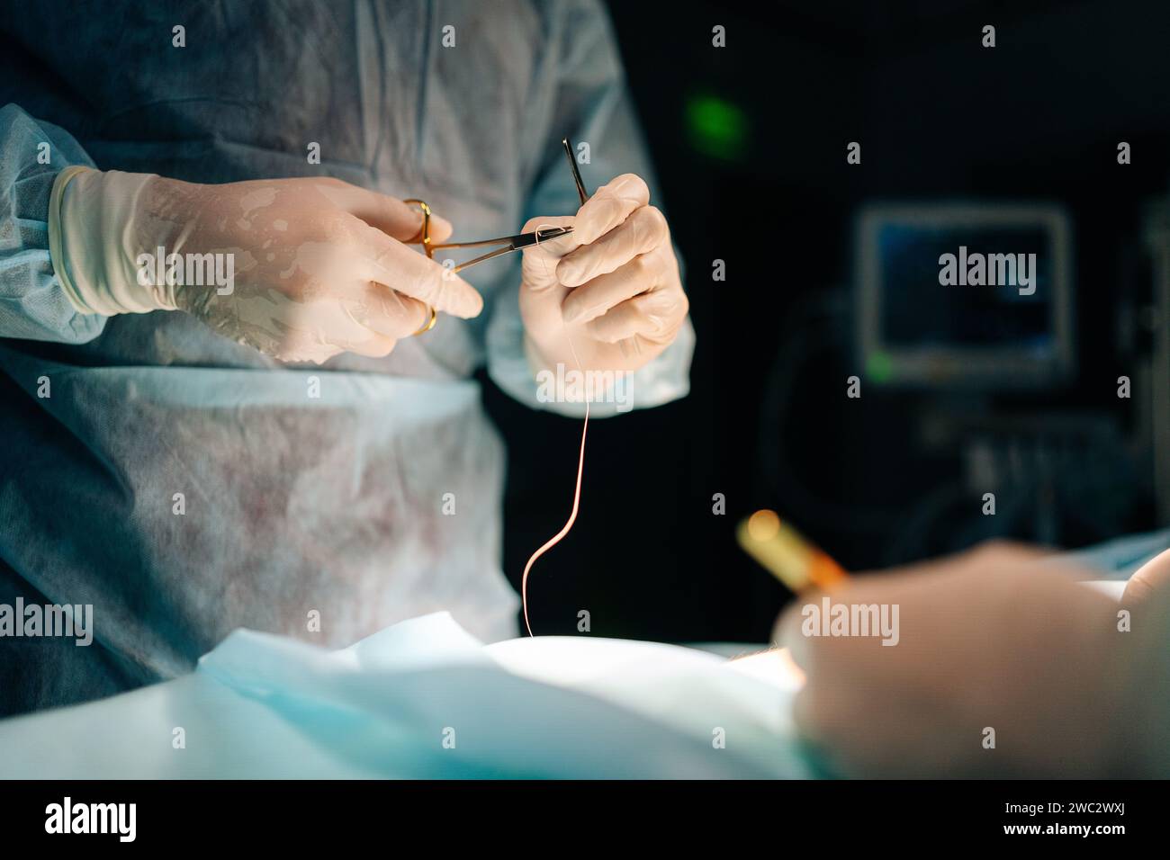 Close-up hands of unrecognizable professional surgeon in hospital doing ...