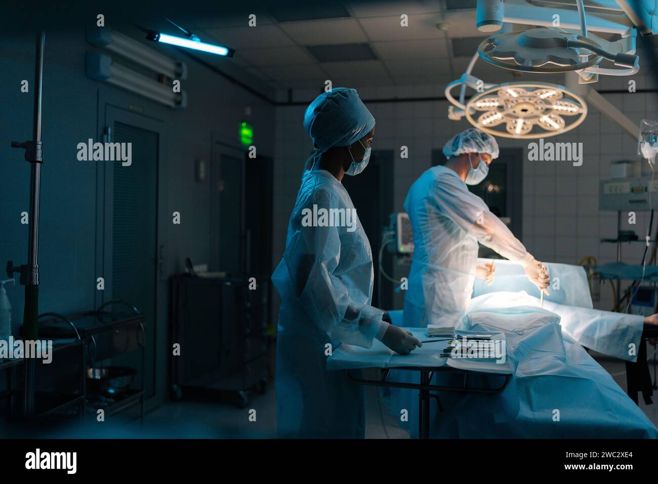 Remote view of male surgeon and African-American female nurse ...