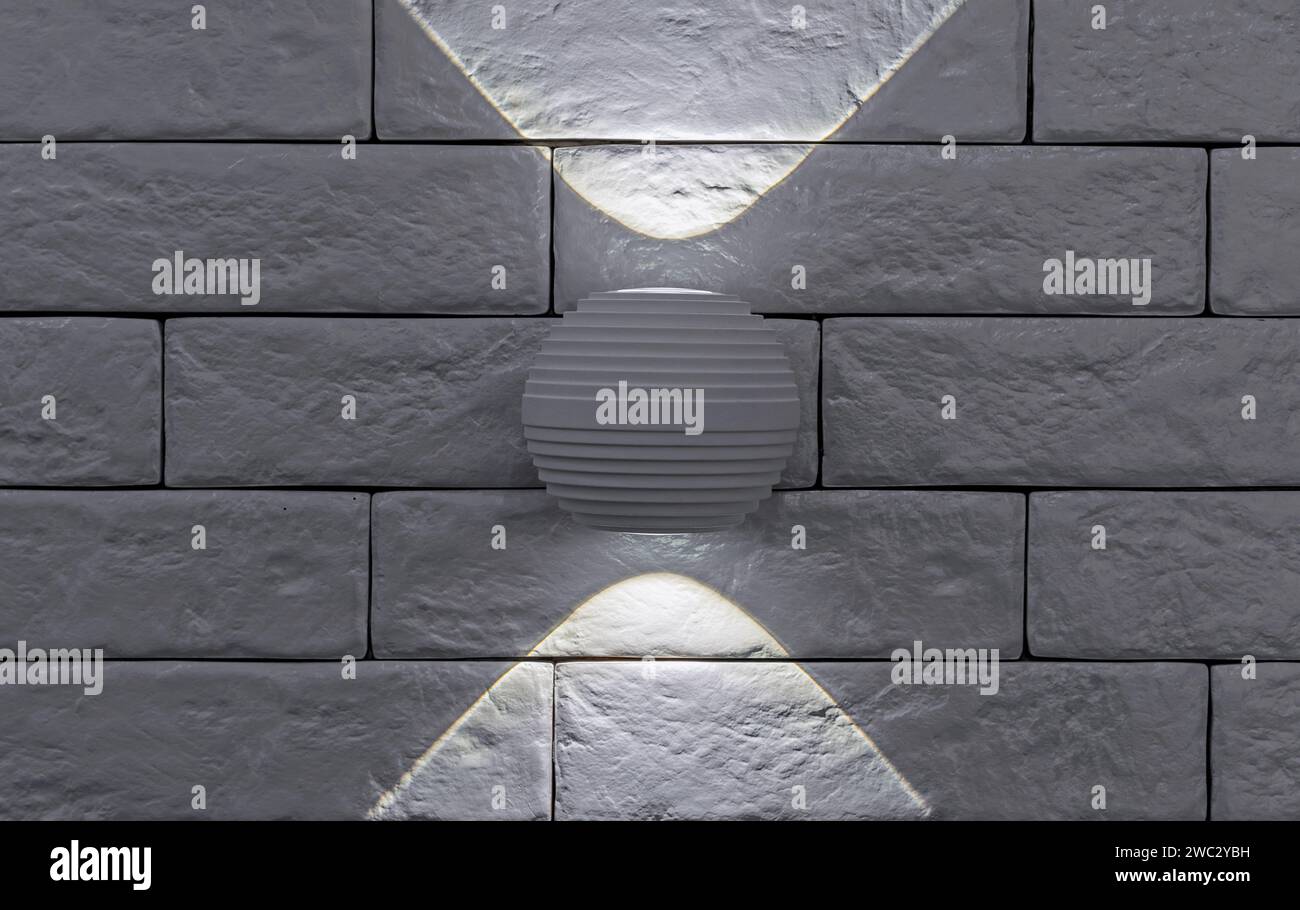 White sconce lamp with top and bottom lighting Stock Photo - Alamy