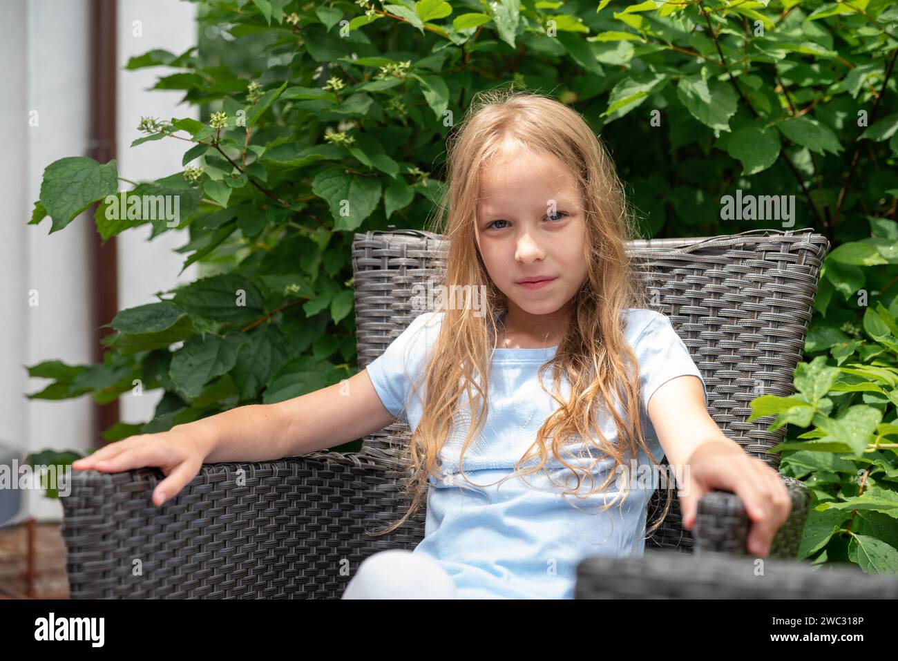 Profile of a cute girl relaxing enjoying fresh air sitting in a chair ...