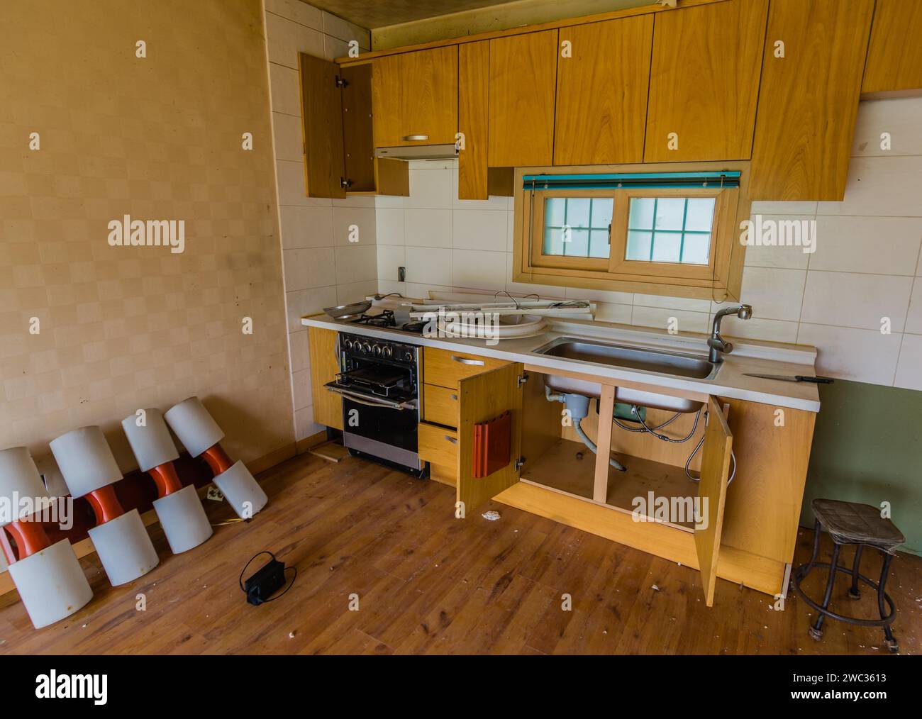 Kitchen area of abandoned house with dirt and electrical fixtures ...