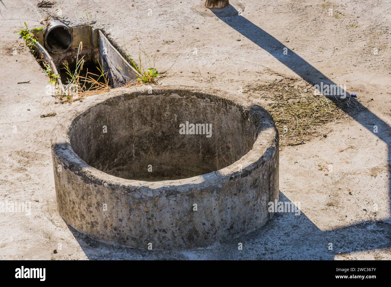 Closeup of concrete irrigation well and drainage pipe used for ...
