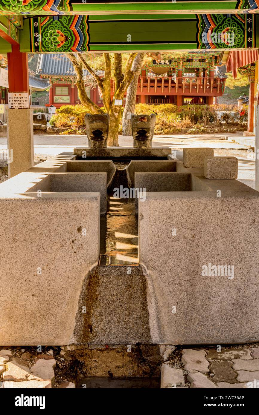 Covered water cistern with dragon head fountains at Buddhist temple ...