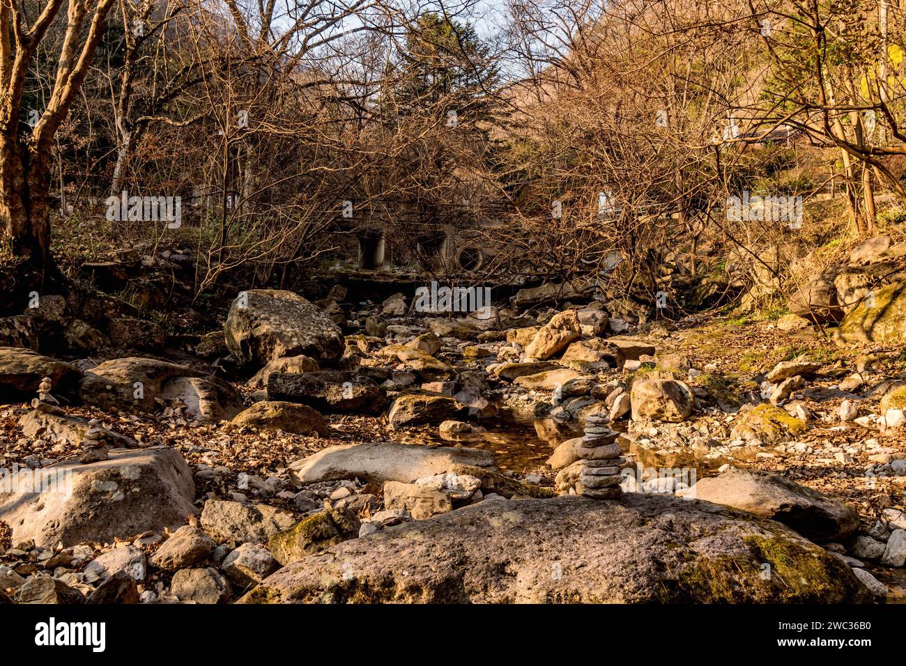 Pebble stack on boulder in dry riverbed in mountain wilderness park ...