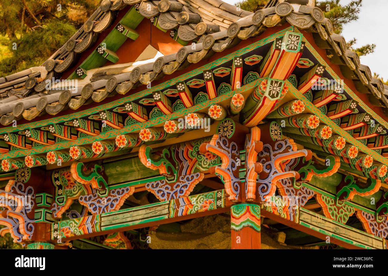 Closeup of oriental building with ceramic tiled roof and colorful ...