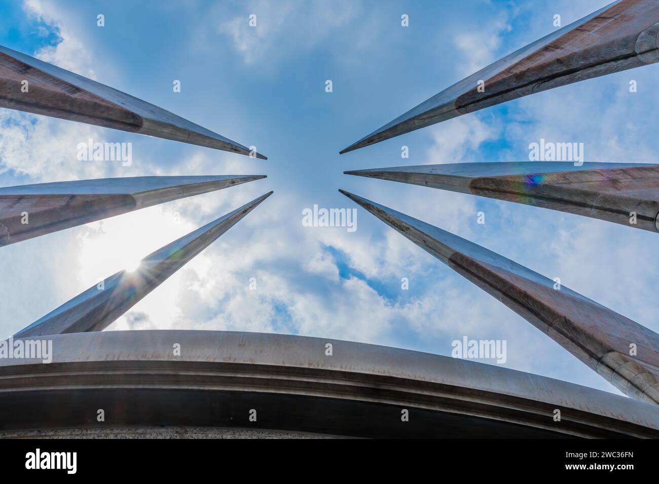 Curved, pointed spires of building reaching into beautiful partly ...