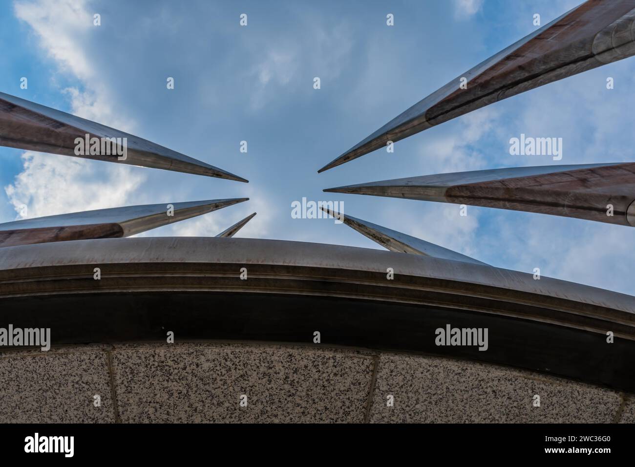 Curved, pointed spires of building reaching into beautiful partly ...