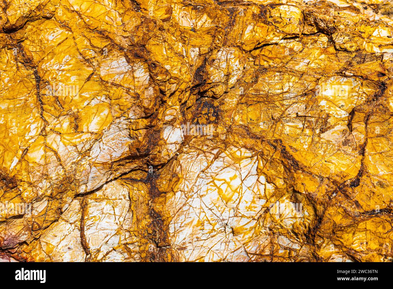 Coloured, ferrous mineral rocks on the beach of Topinetti, near Rio ...
