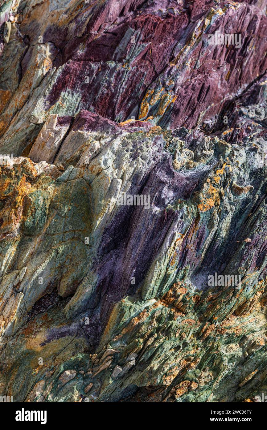 Coloured, ferrous mineral rocks on the beach of Topinetti, near Rio ...