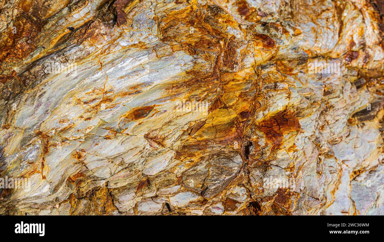 Coloured, ferrous mineral rocks on the beach of Topinetti, near Rio ...