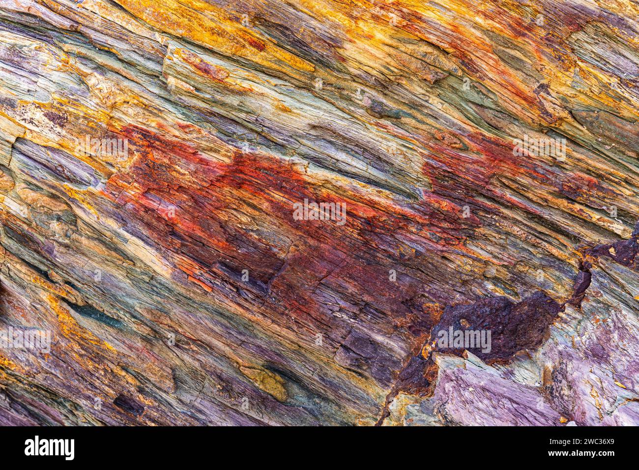 Coloured, ferrous mineral rocks on the beach of Topinetti, near Rio ...