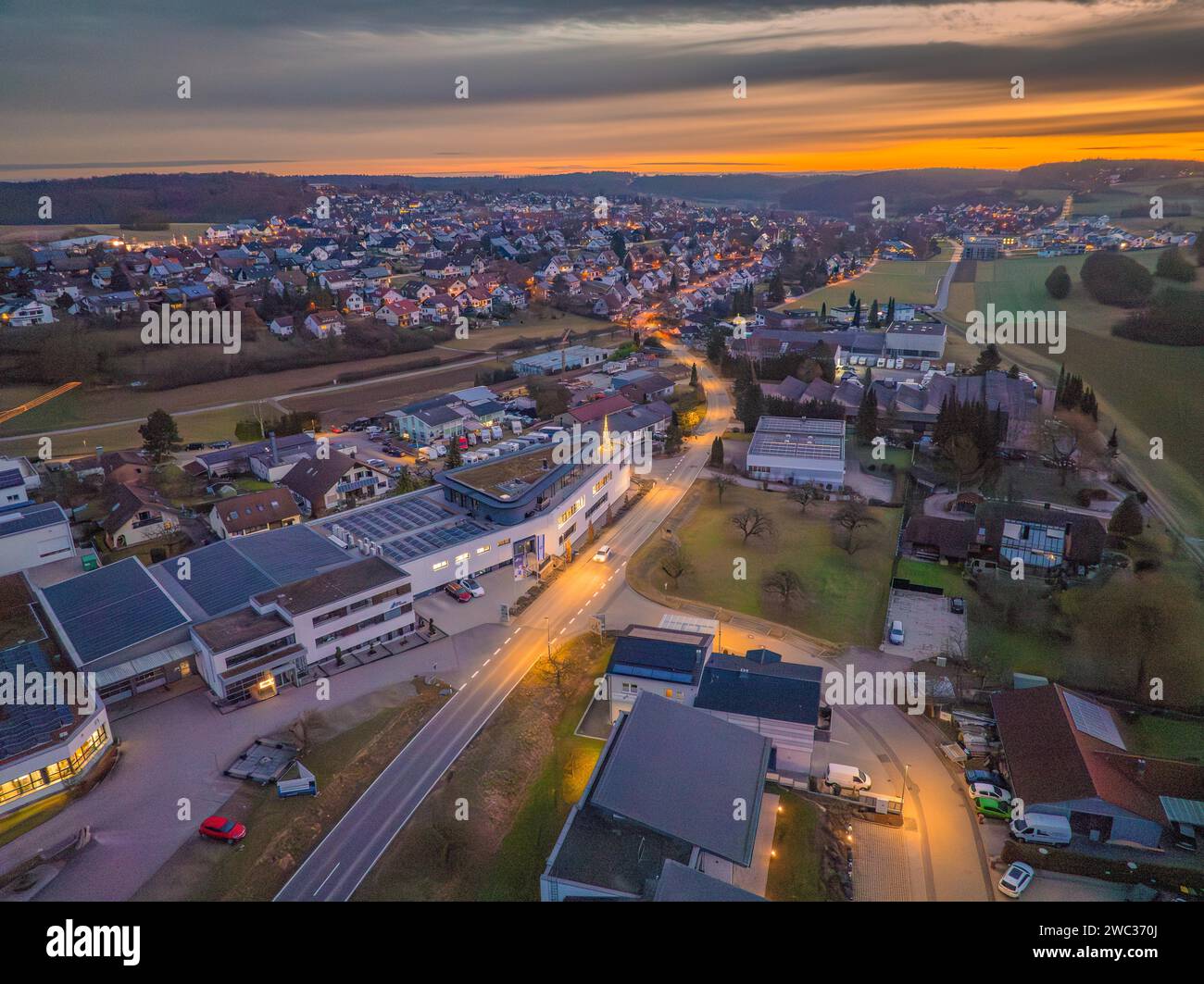 Evening aerial view of a town with illuminated streets, Christmas tree ...