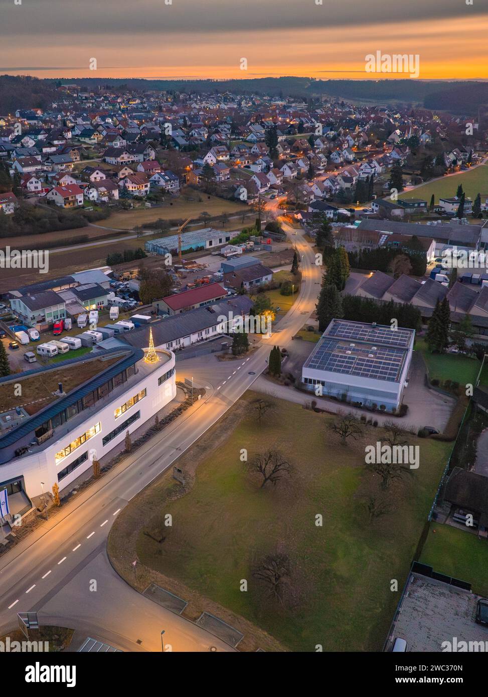Aerial view of a cityscape with street lighting in the evening ...
